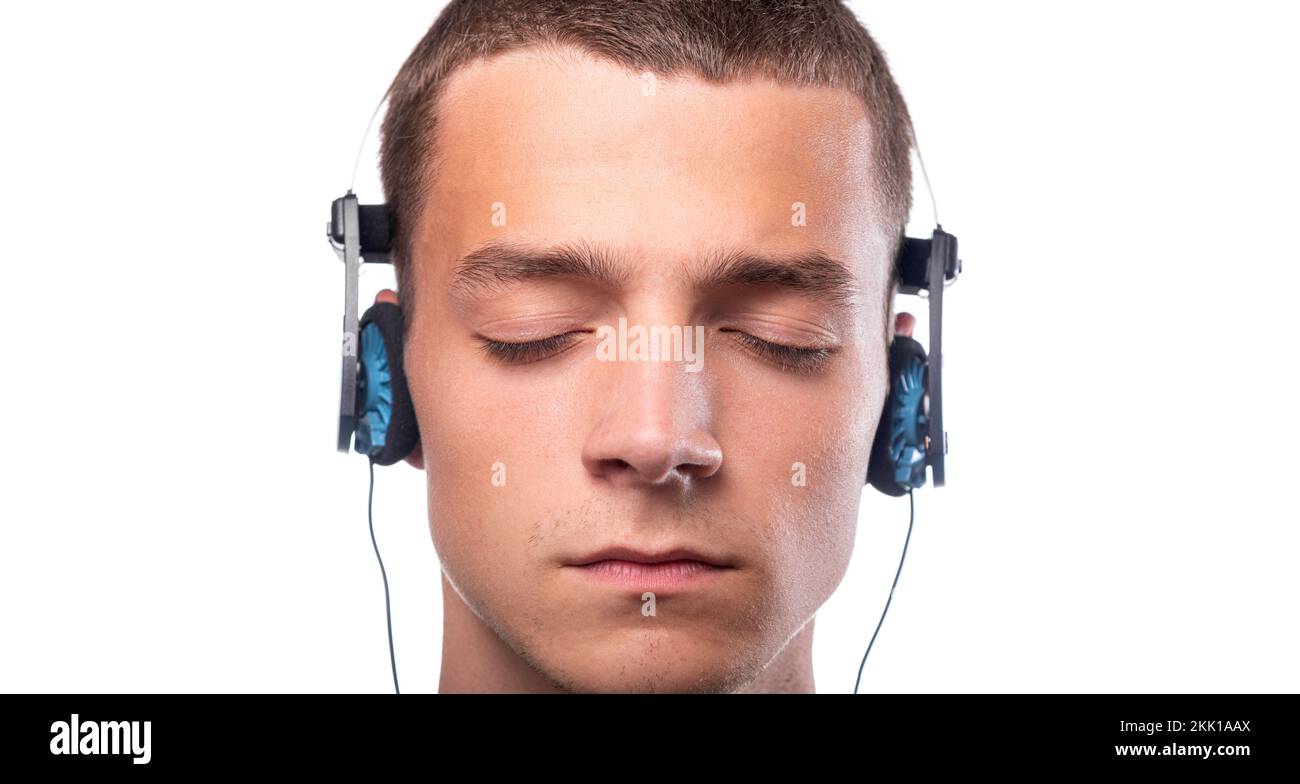 Young guy in headphones on a white background Stock Photo - Alamy