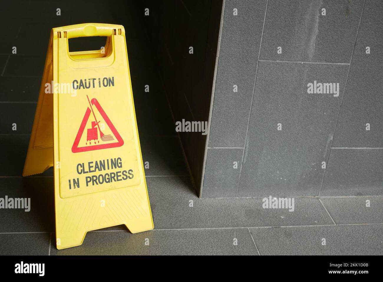 Caution wet floor signage on office floor Stock Photo - Alamy