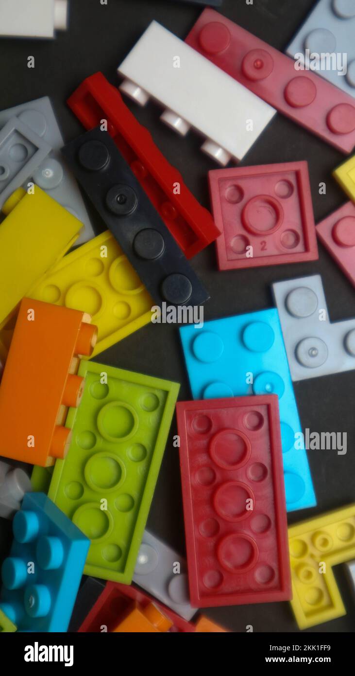 Plastic toy blocks on black background Stock Photo - Alamy