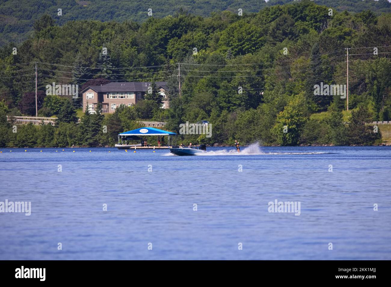 A water skier seen on Hunters Bay Lake while North bound traffic passes ...
