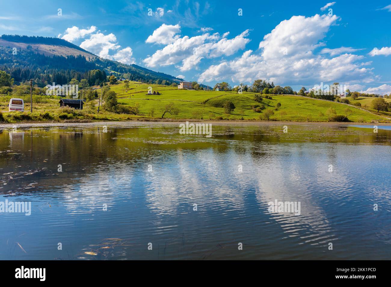 A scenic view of a lake reflecting the sky in Bukovets, Ukraine Stock ...