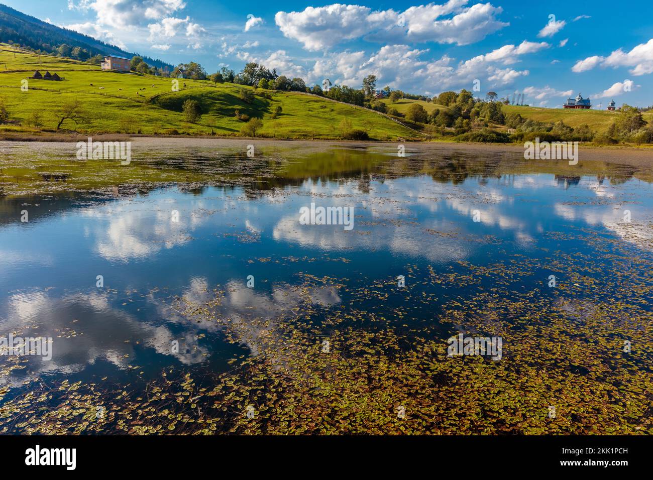 A scenic view of a lake reflecting the sky in Bukovets, Ukraine Stock ...