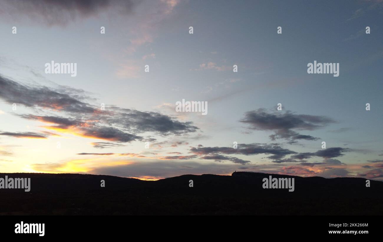 A low angle shot of the colorful sunset sky above the silhouettes of ...