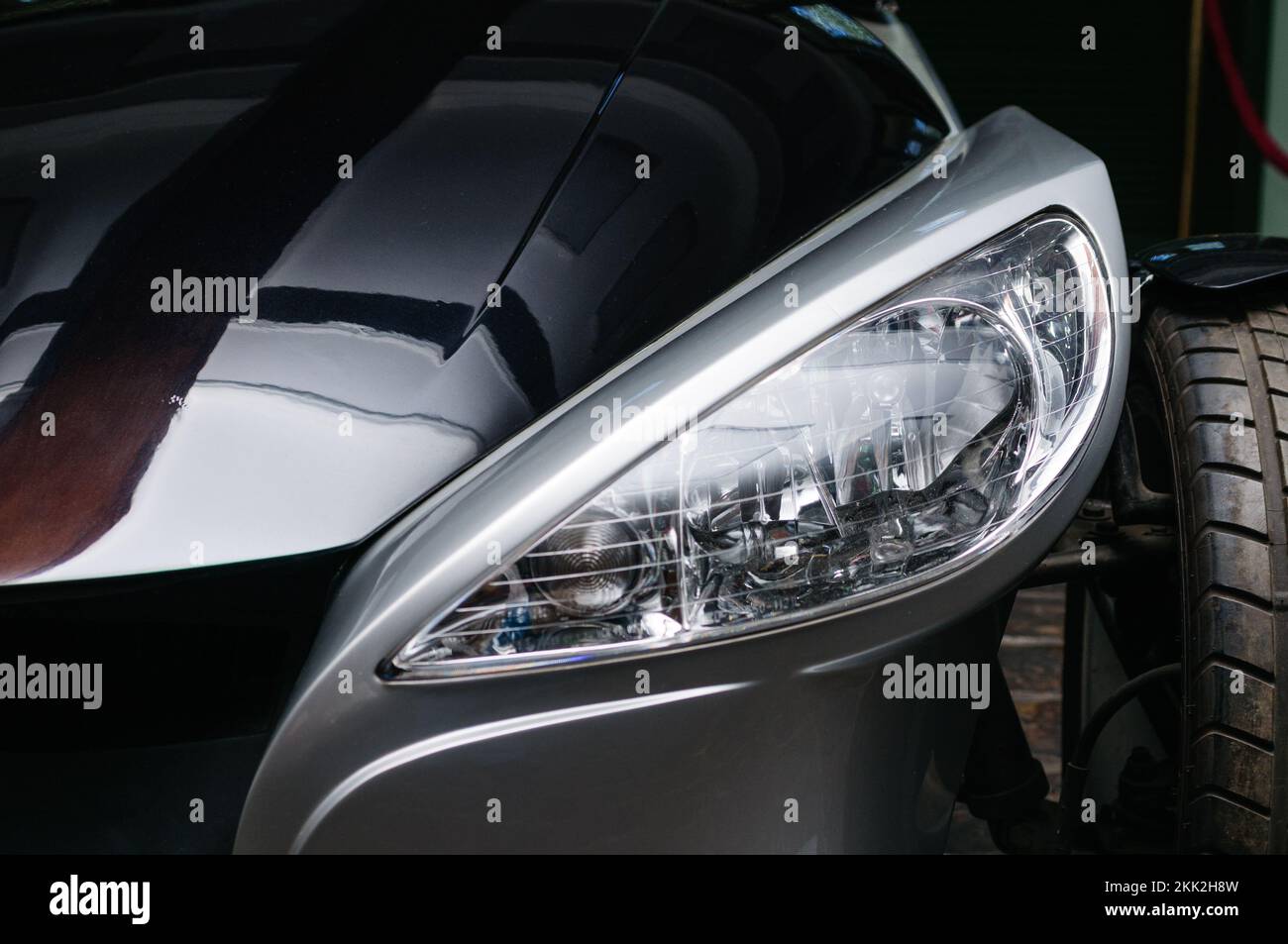 Front view of the headlights modern car on black background, copy space ...