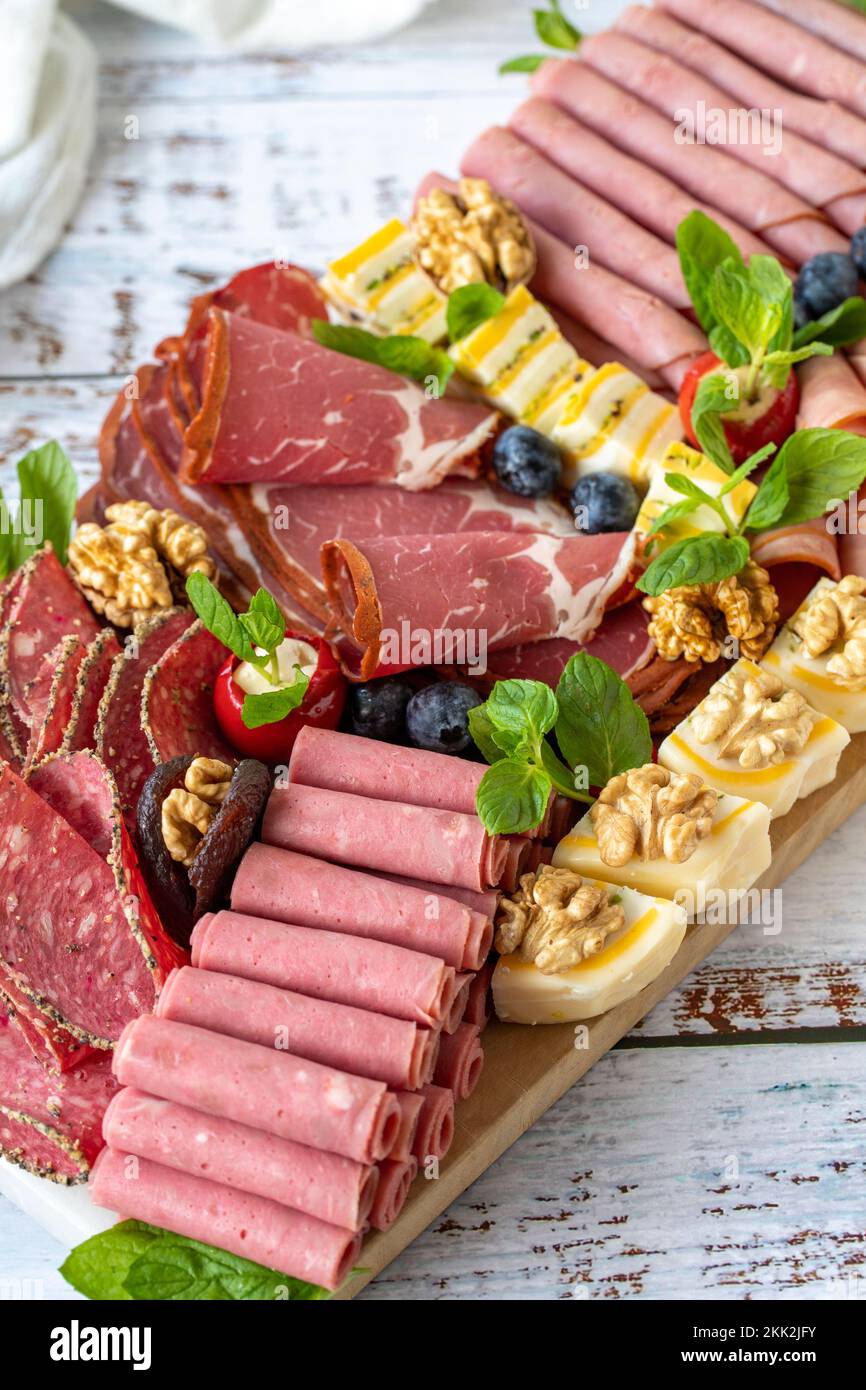 Cold Smoked Meat Plate on wood floor. Antipasto set plater wooden plate ...