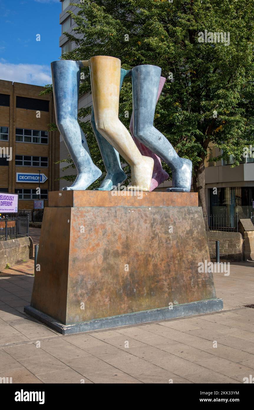 A vertical closeup of colorful Legs Walking sculpture near Leeds ...