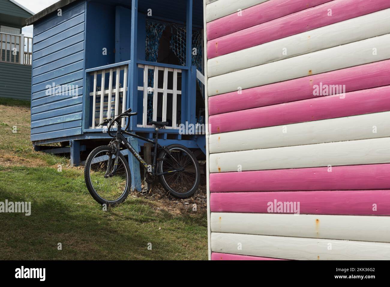 Bike leaning on beach huts hi-res stock photography and images - Alamy
