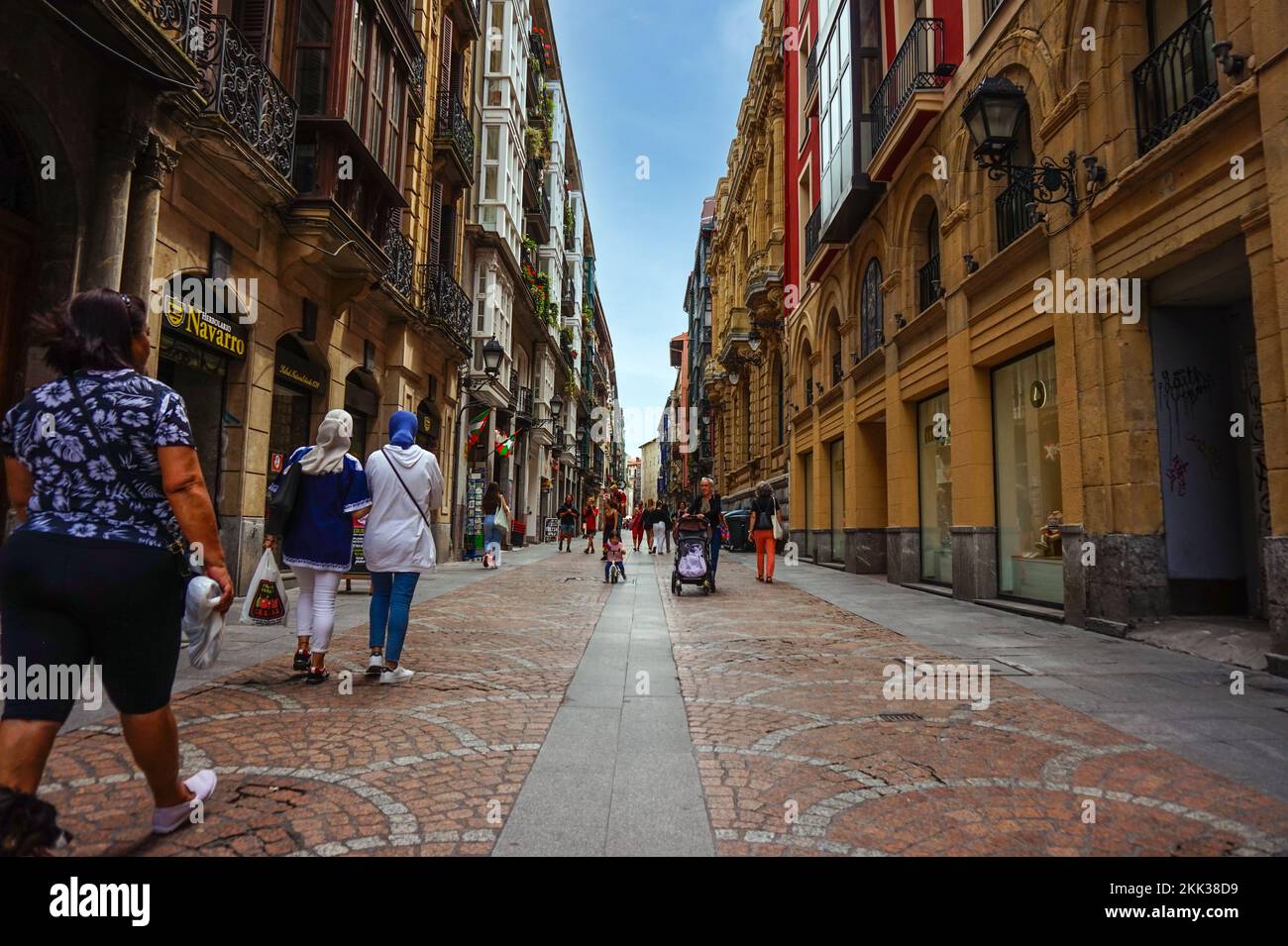 A busy street with people and old buildings in Bilbao, Spain Stock ...