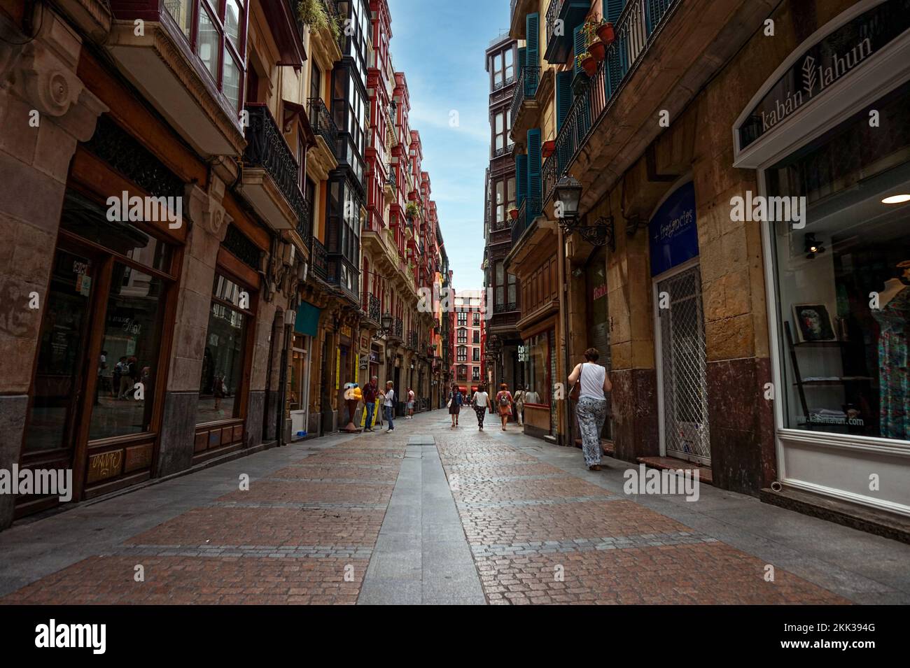 A busy street with people and old buildings in Bilbao, Spain Stock ...
