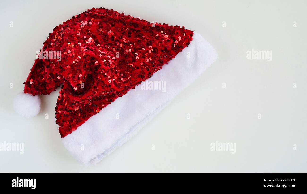 Close-up of a red shiny santa claus hat on a white background,top view ...