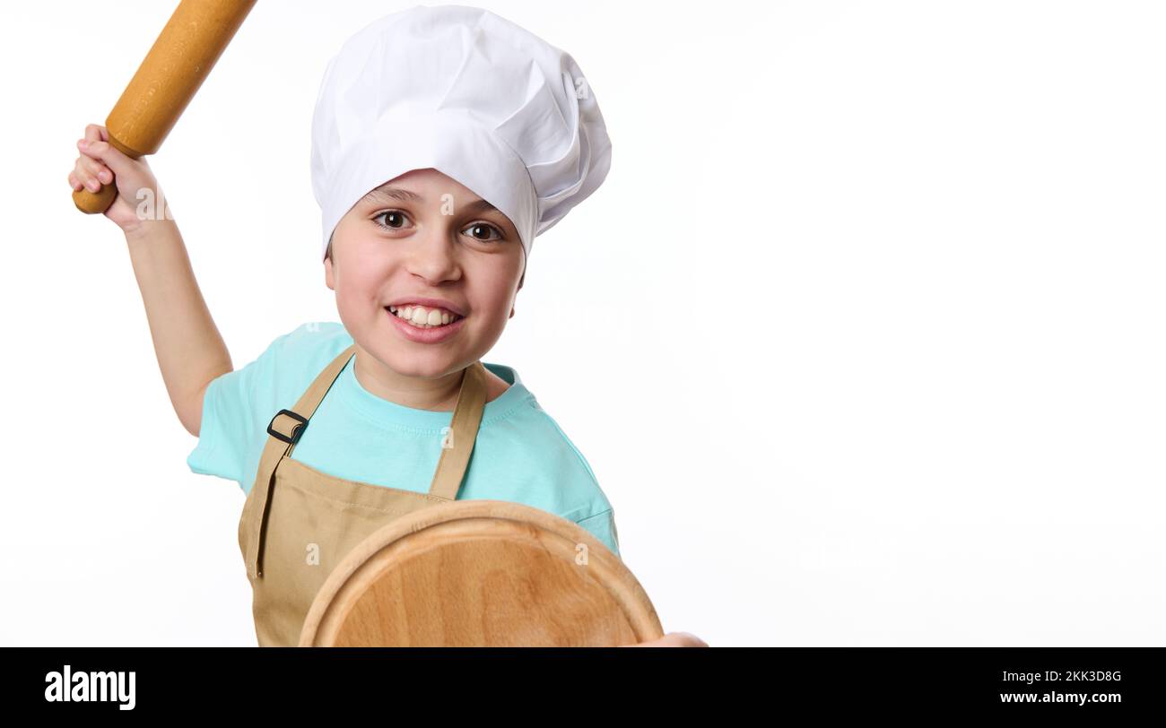 Close-up smiling mischievous boy fighting with wooden board and rolling ...