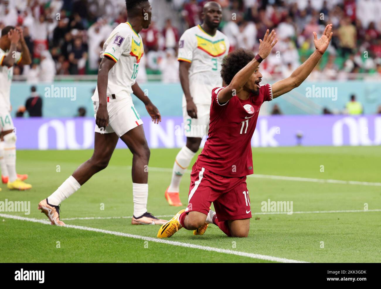 Doha, Qatar. 25th Nov, 2022. Akram Afif (R) of Qatar reacts after ...