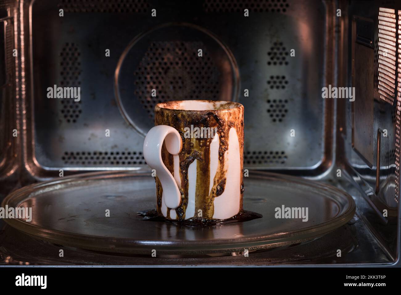 Spilt overflowed coffee drink in microwave causing serious mess to ...