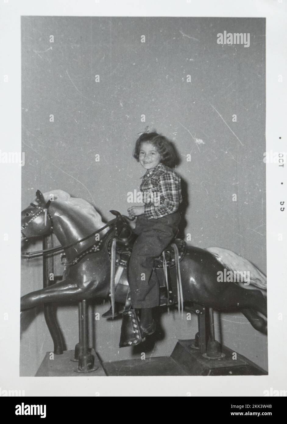 Child on a mechanical rocking horse ride in a Canadian department store ...