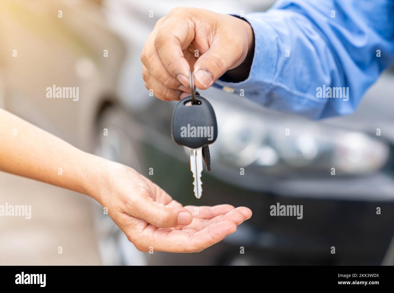 Close up car salesman handing keys to customer when finish leasing on ...