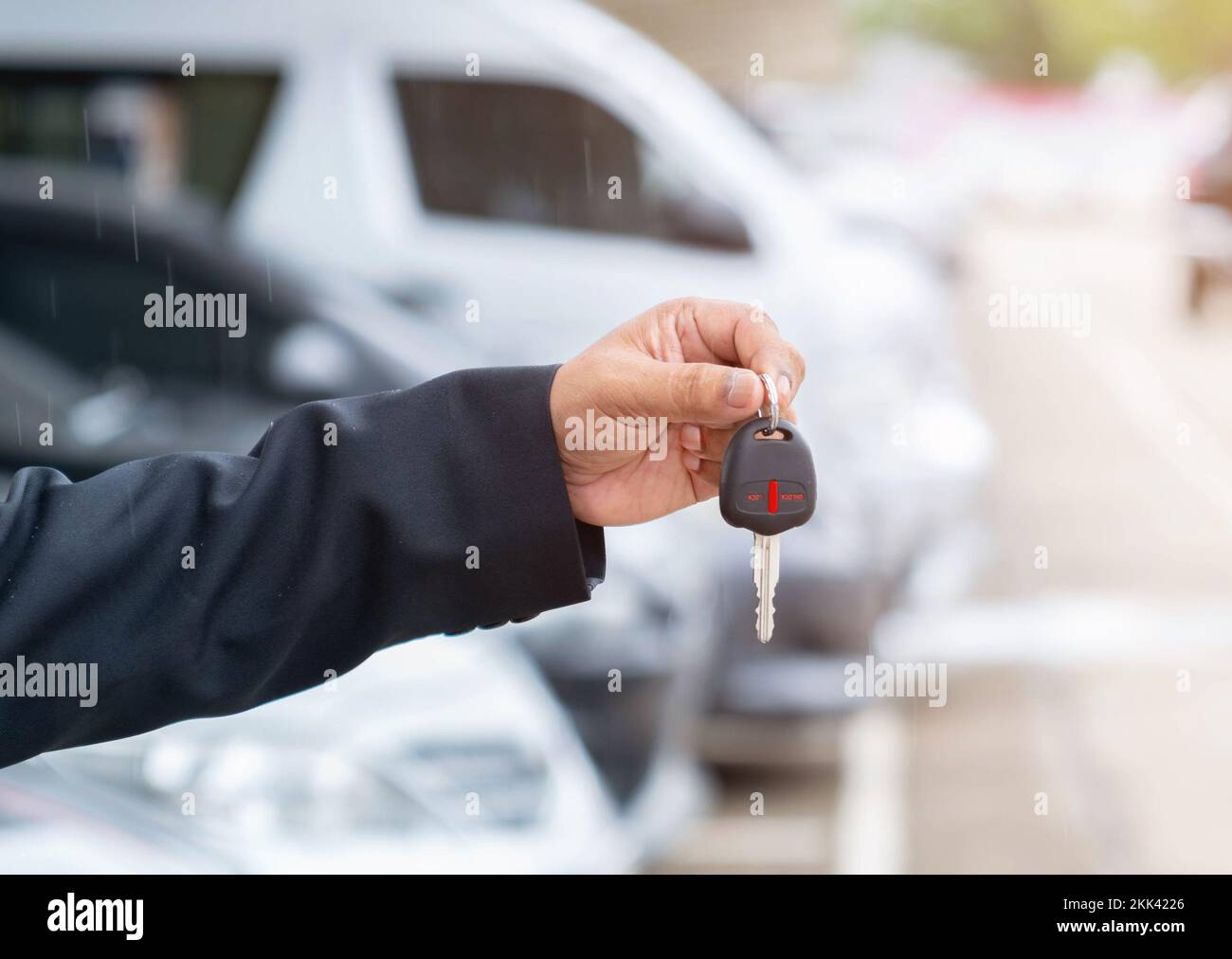 Business man's hand holding car key.Automobile rent or leasing concept ...