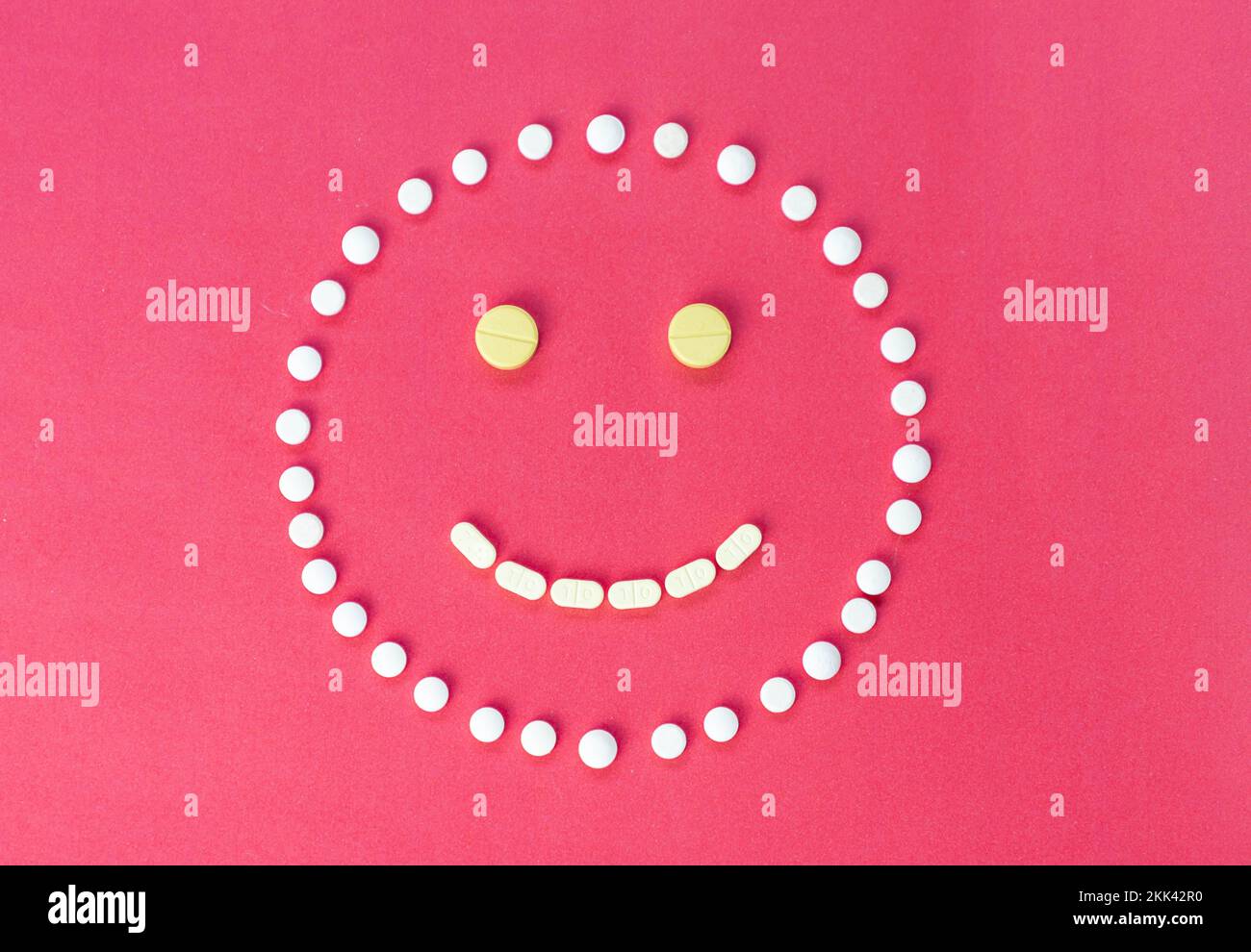 Pill arange icon face smile on red background symbol of feeling good in ...