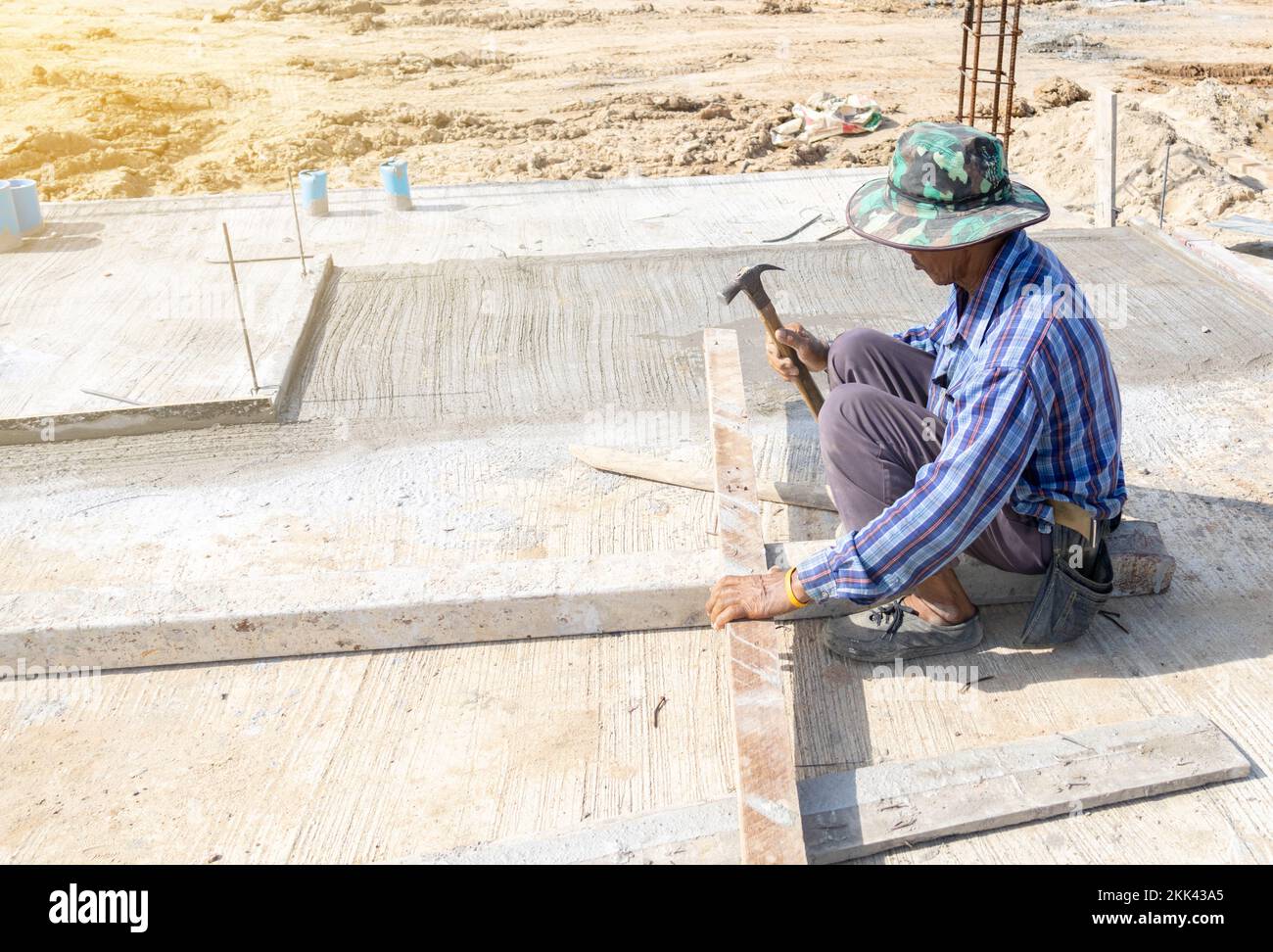 Worker use hammer hit nails on formwork in construction site Stock ...