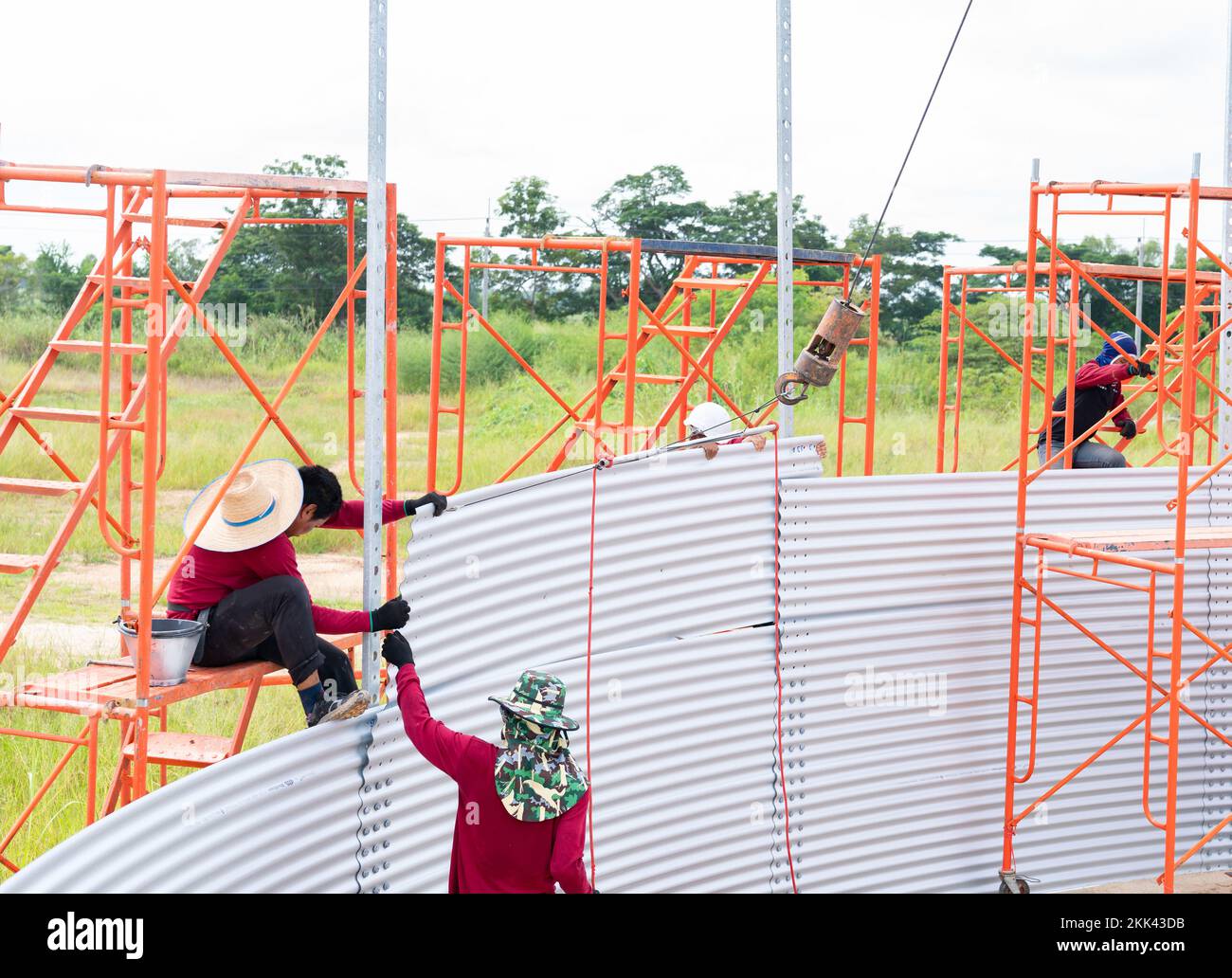 Technician assembly metal sheet silo wall in construction site Stock ...