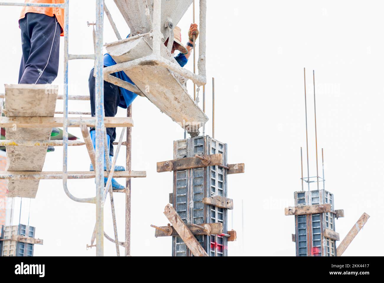 Worker pour concrete from bucket for cast the structural columns in ...