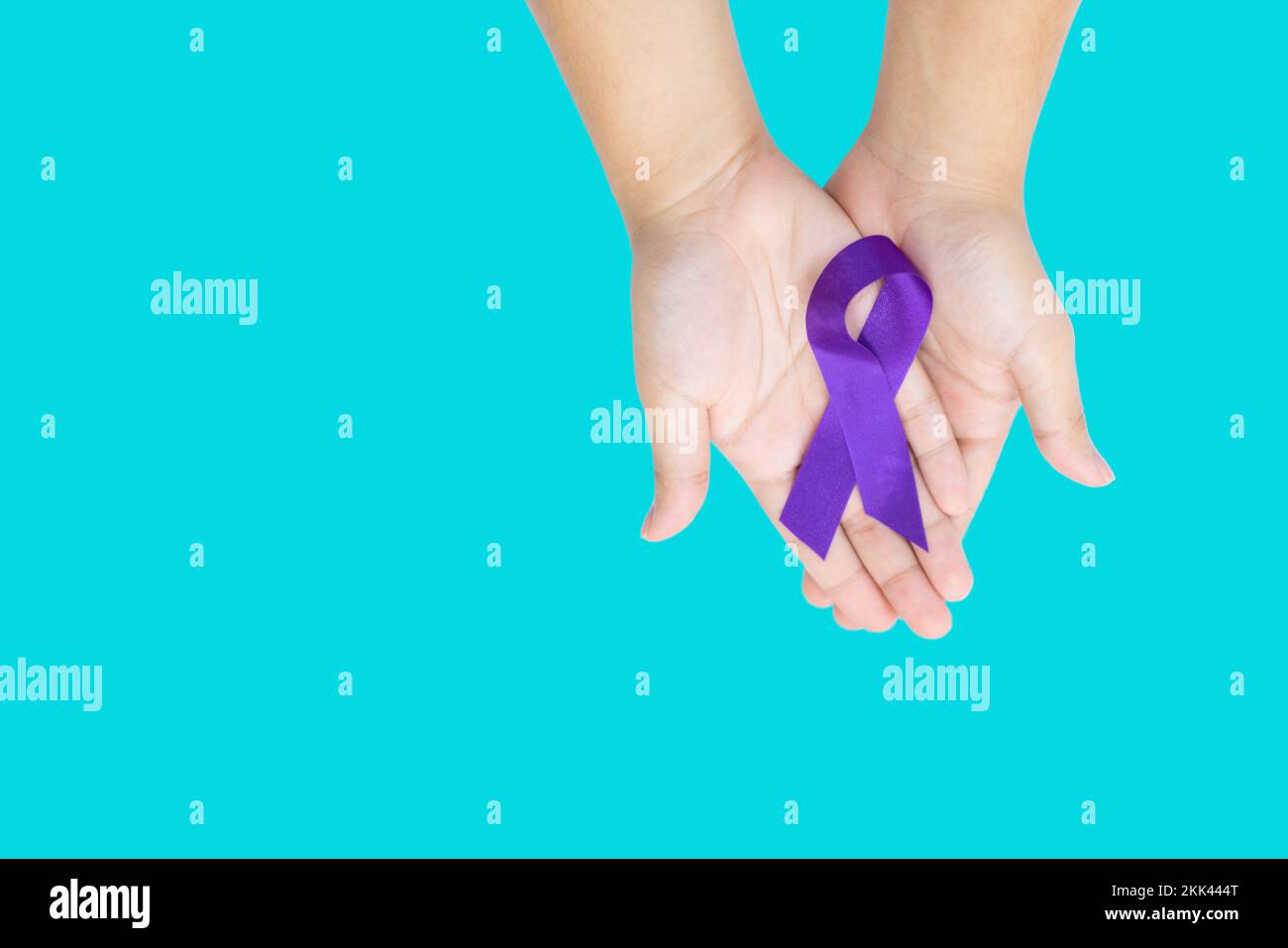 Purple ribbon in two hand on isolate aqua blue background. Concept of ...