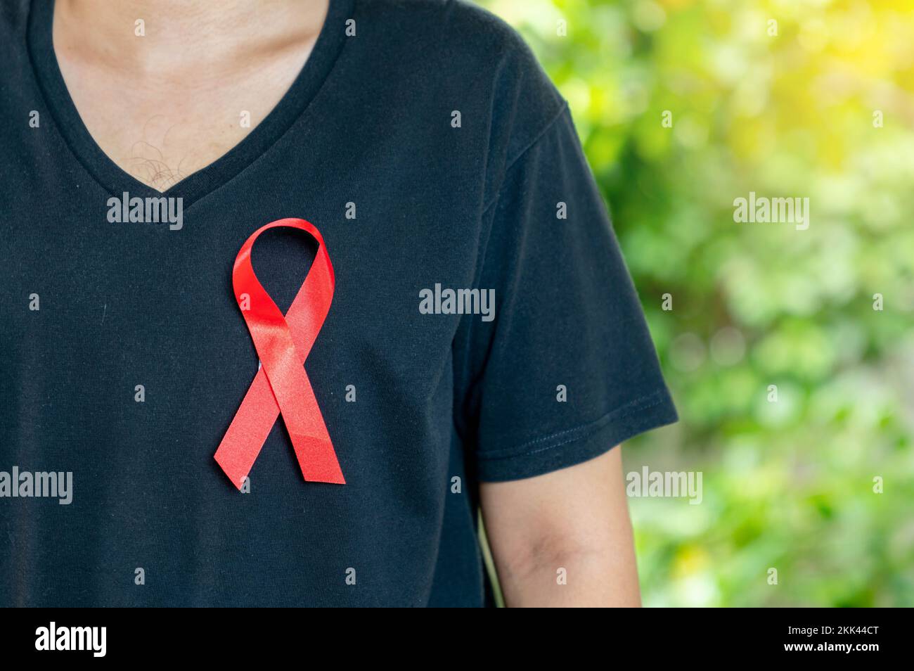 Red ribbon on black shirt for the fight against AIDS, world AIDS day ...