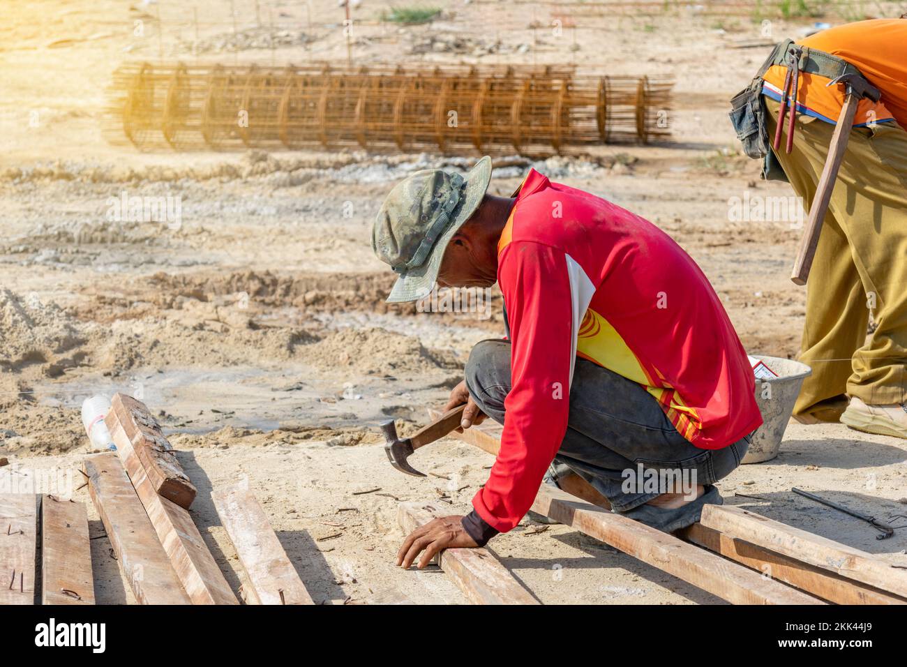 Construction worker use hammeer remove nails on wood stick in building ...