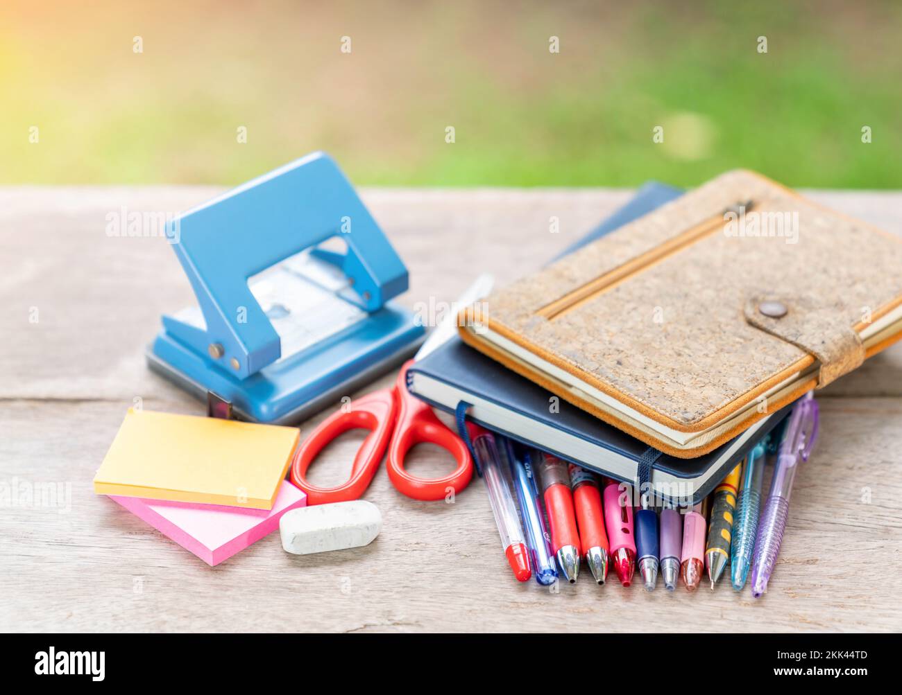 Stationary and notebook paste on wooden table and out of focus ...