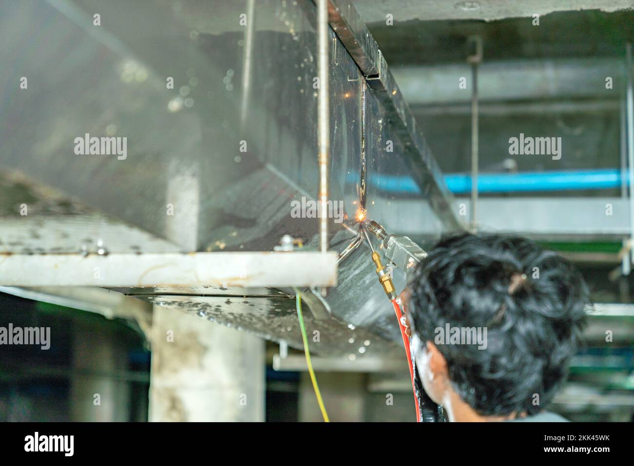 Technician welding stainless steel trough underground building Stock ...