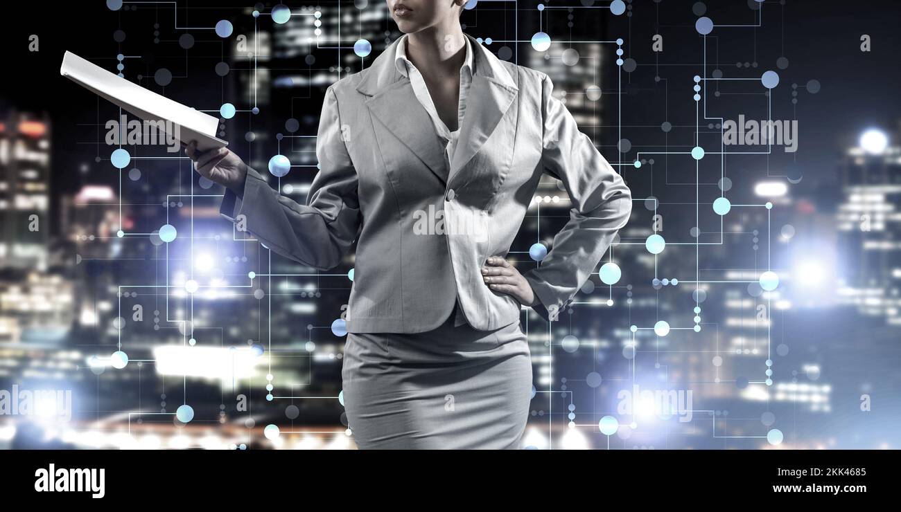Close of businesswoman against night cityscape background and ...