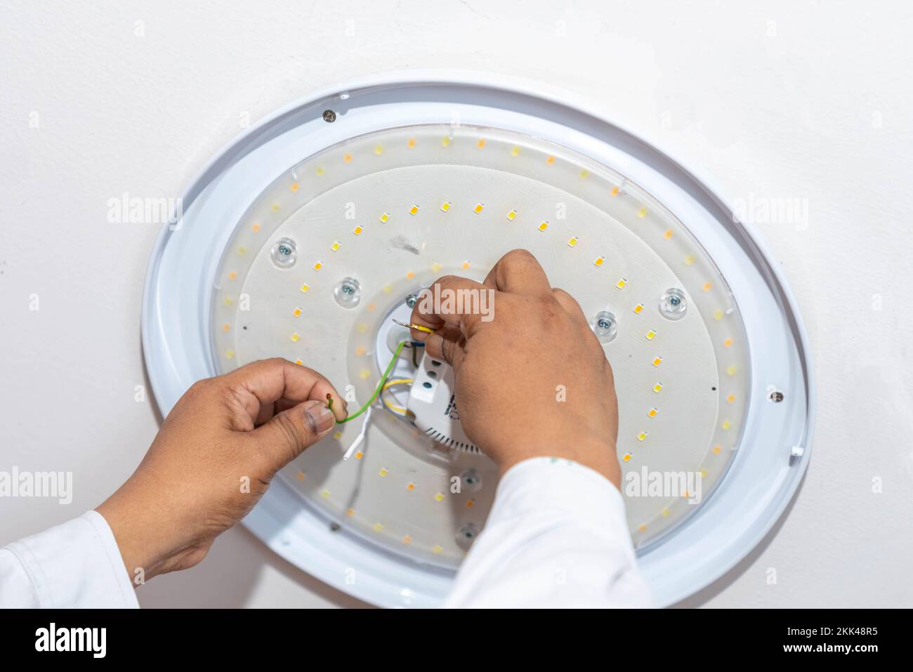 Hand changing light bulb close hi-res stock photography and images - Alamy