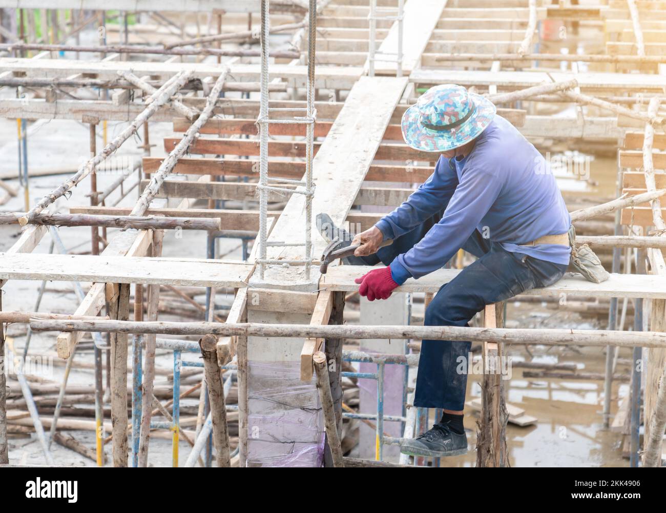 Worker hit nails on second floor for instruction formwork in building ...