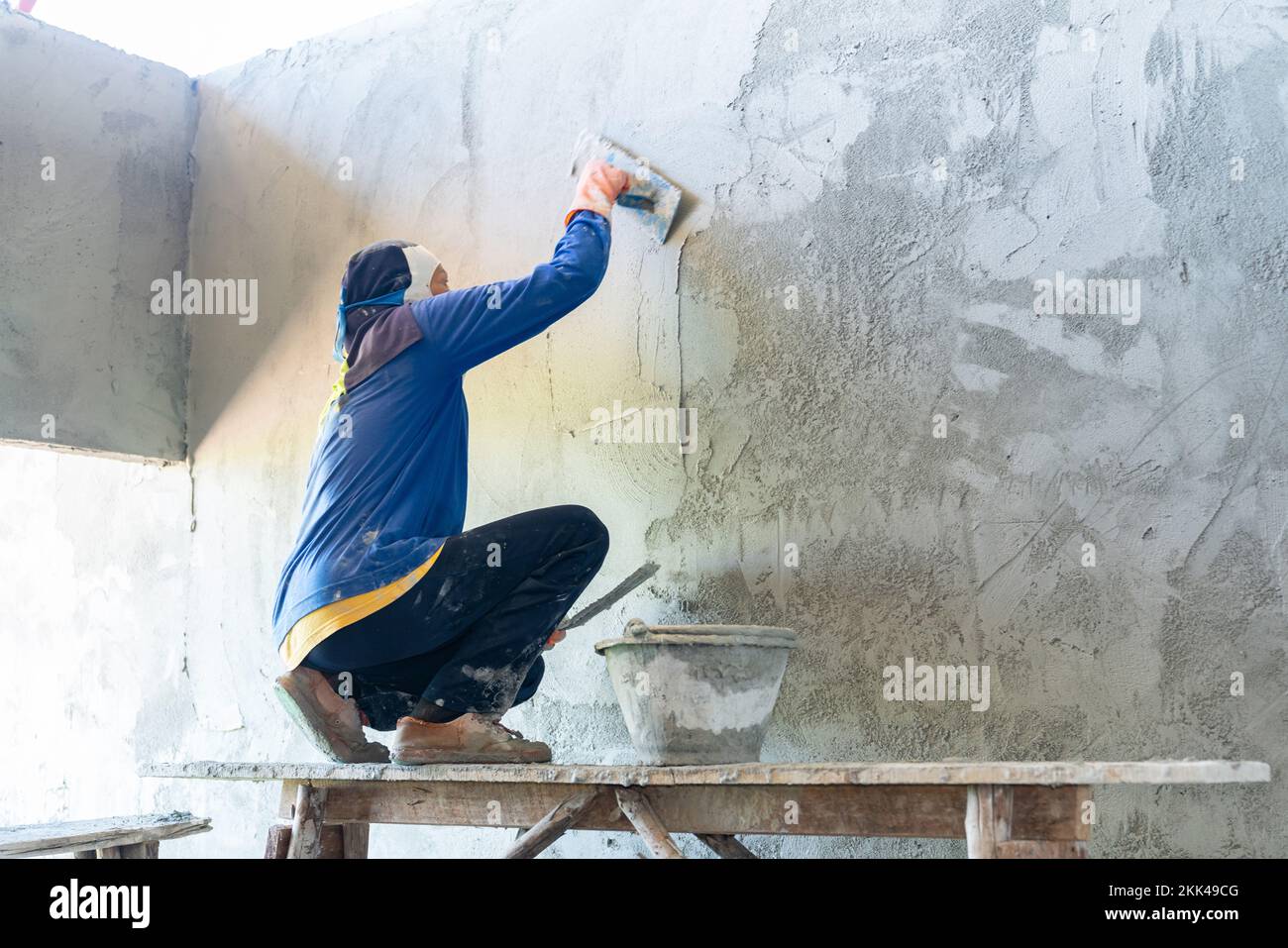 Hand of plastering wear rubber gloves to prevent cement mortar to bite ...