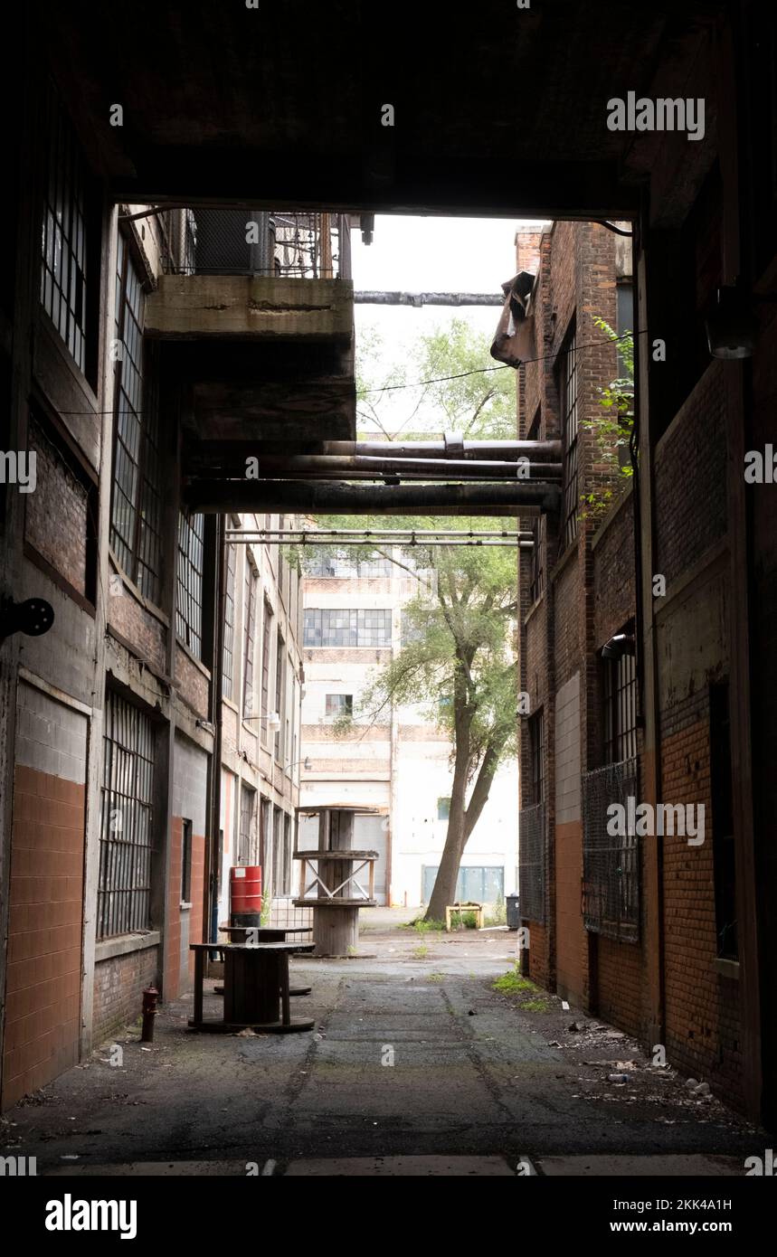 A vertical shot of a dusty passage between two buildings in a city ...