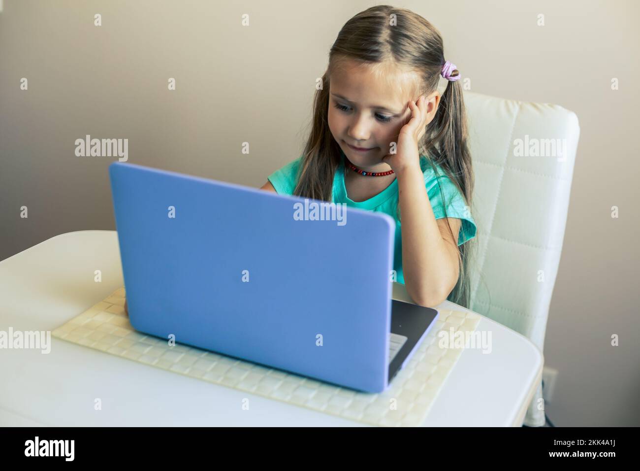 Little cute girl uses laptop to have video call Stock Photo - Alamy