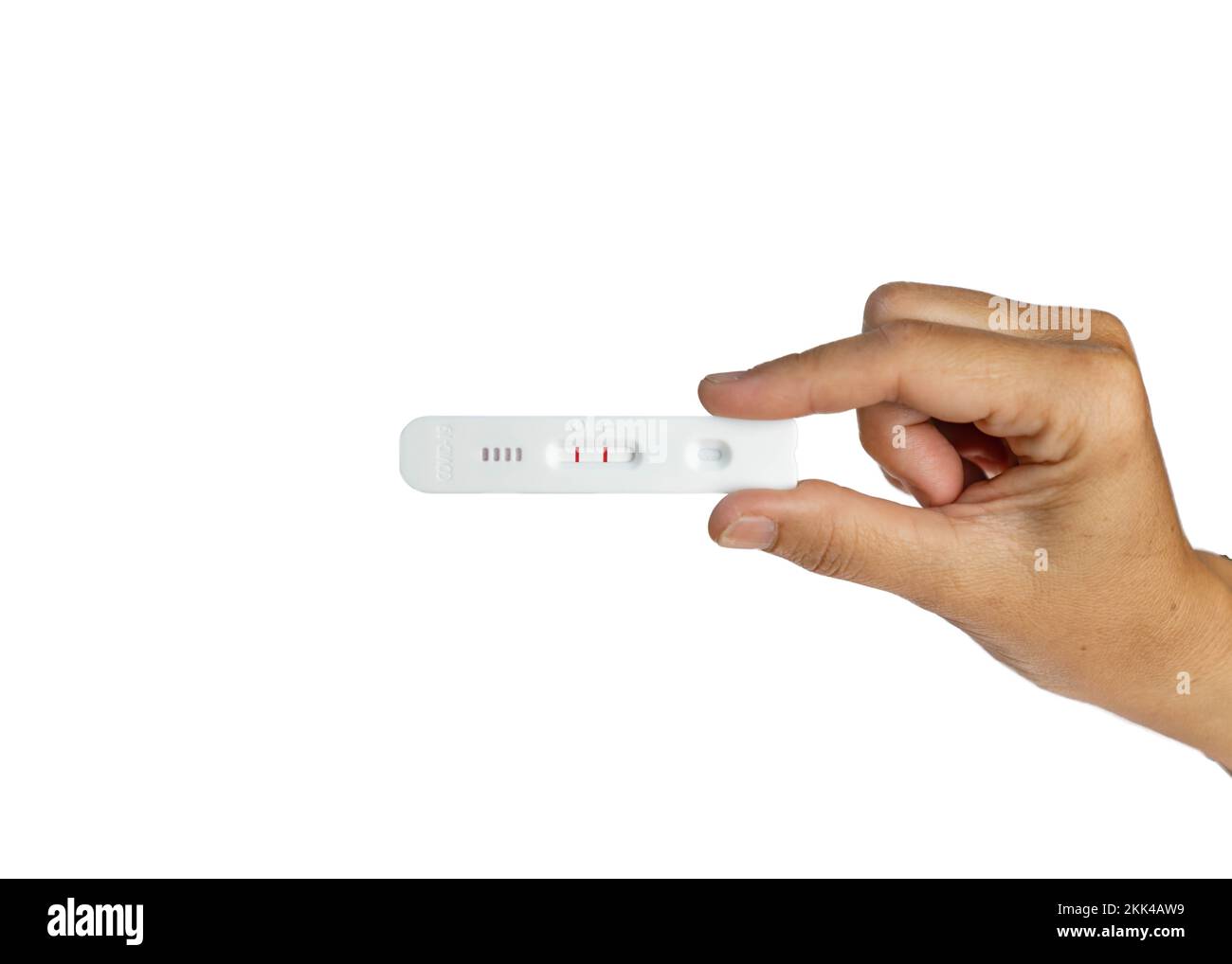 Close-up of a hand holding a positive antigen test for COVID-19 isolate ...