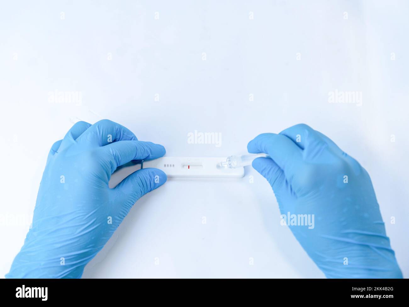Using a covid 19 rapid test - test liquid is filled into the test ...