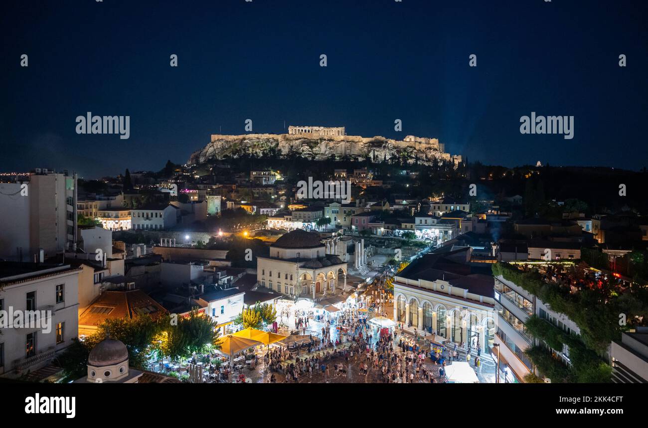 The crowded Monastiraki Square and Acropolis at night Stock Photo - Alamy