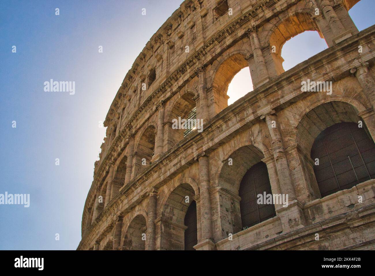 A beautiful low angle shot of the famous Roman Colosseum under clear ...