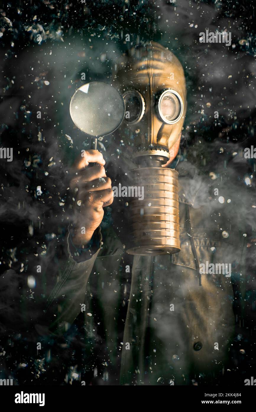 Creative portrait on a scientist wearing a gas mask while holding a ...