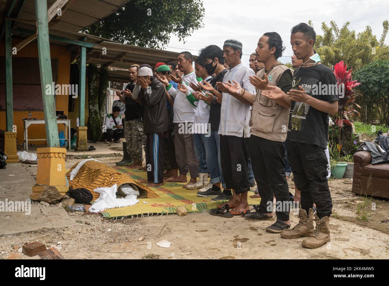 Cianjur, West Java, Indonesia. 25th Nov, 2022. People pray over the ...