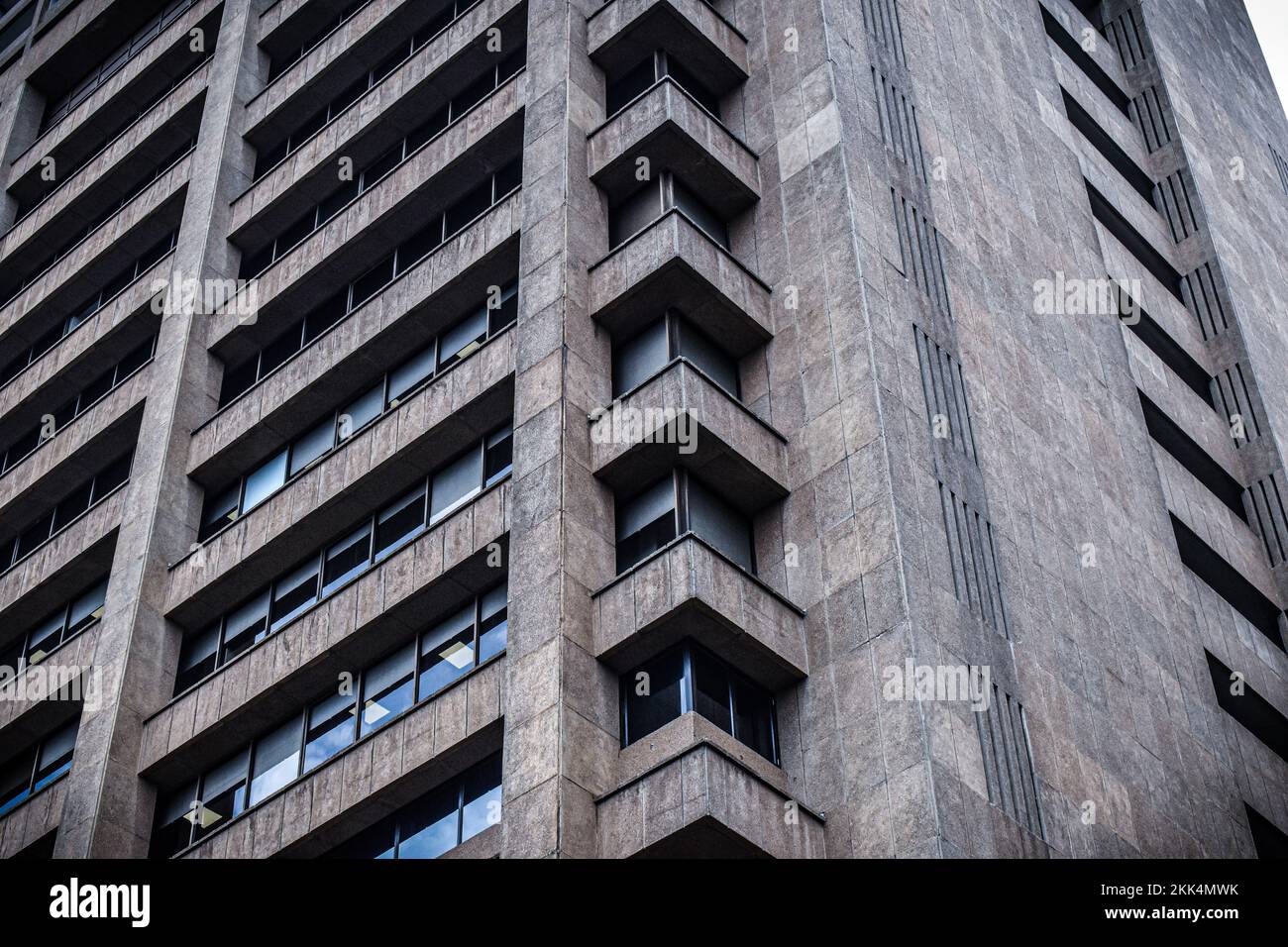 A low angle shot of a tall and massive stone building Stock Photo - Alamy