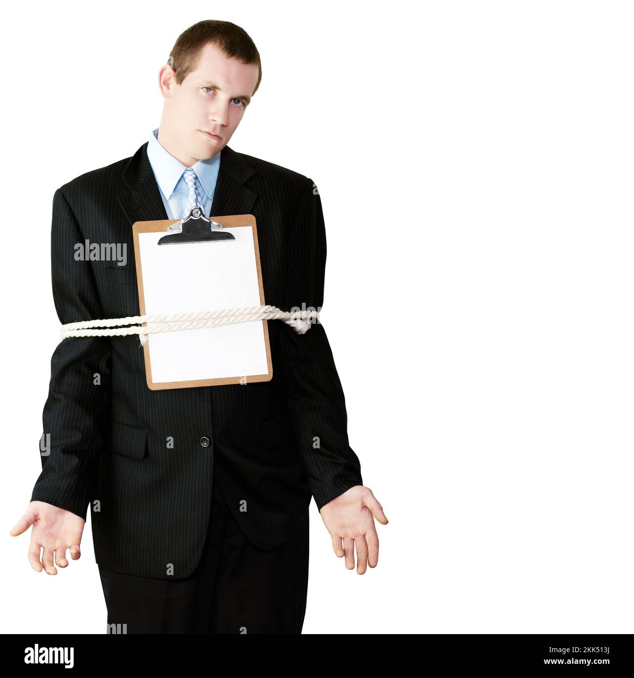 Handsome businessman standing with a clipboard with blank paper on his ...