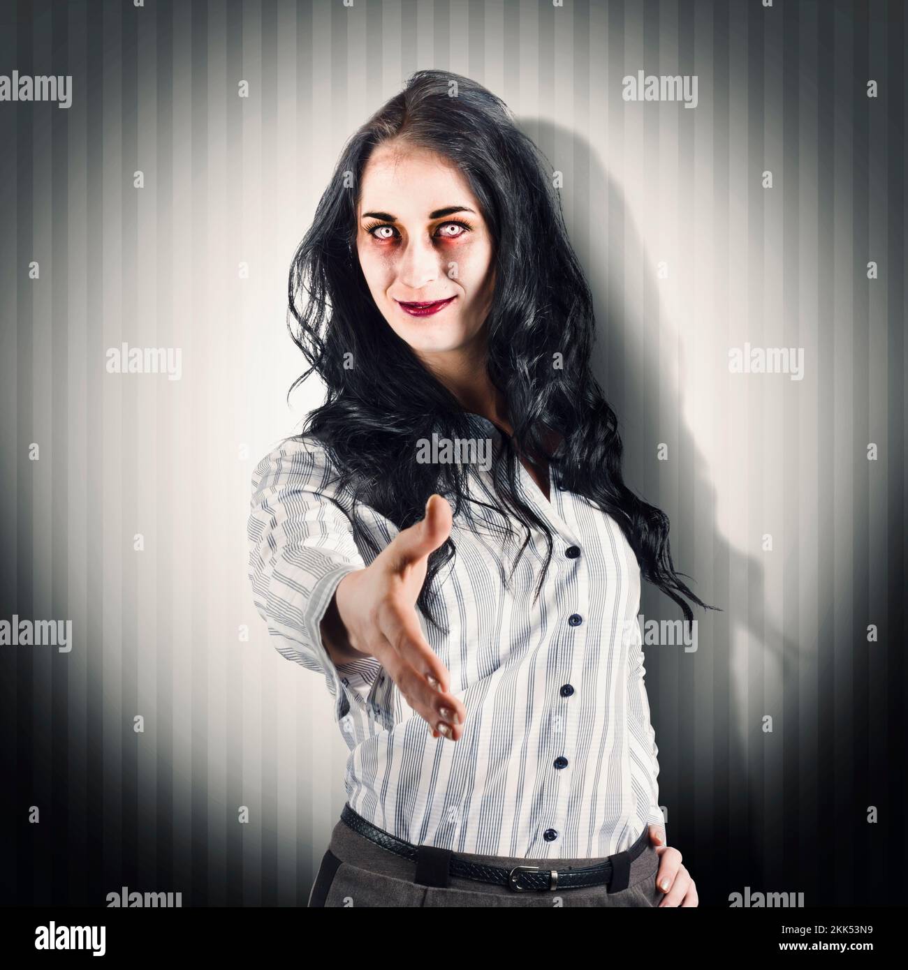 Dead vintage businesswoman making a deal with the devil when holding ...