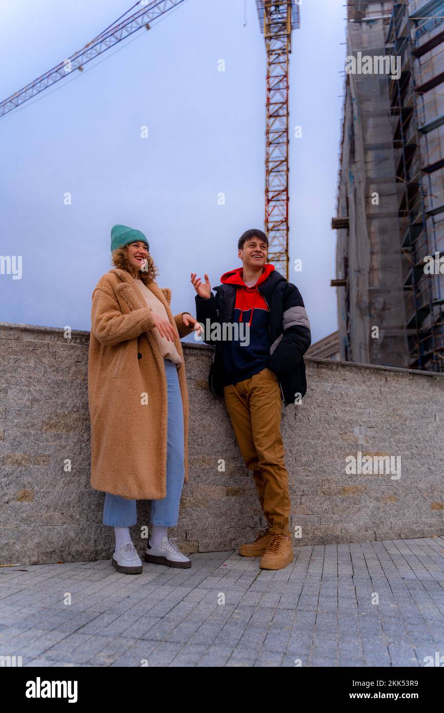 Two attractive and young people are having a date outside while having ...