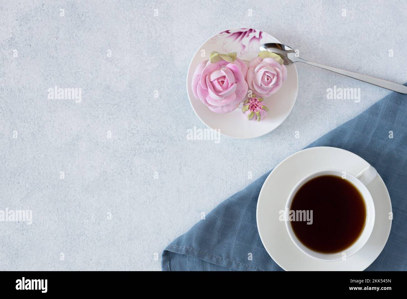 tea set in a composition with marshmallow flowers. Coffee mug on a ...