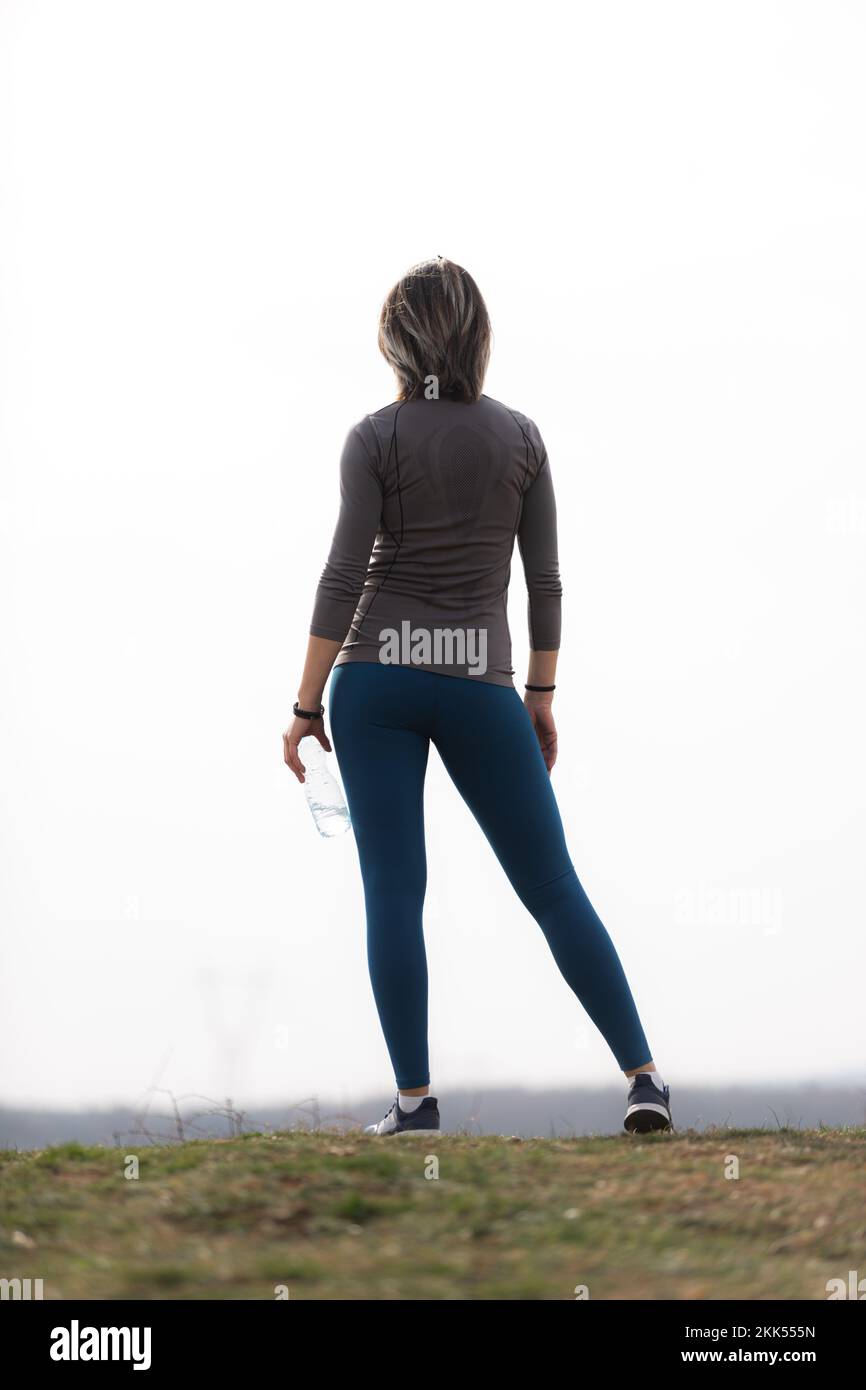 Amazing and active woman is standing and taking a break Stock Photo - Alamy