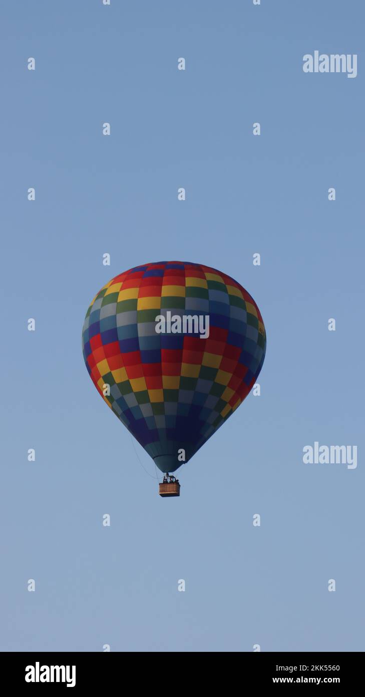 A vertical shot of a colorful hot air balloon in the blue sky Stock ...