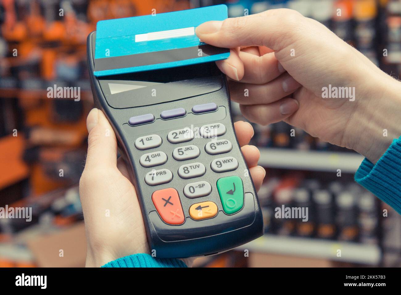 Hand of woman using payment terminal with contactless credit card ...