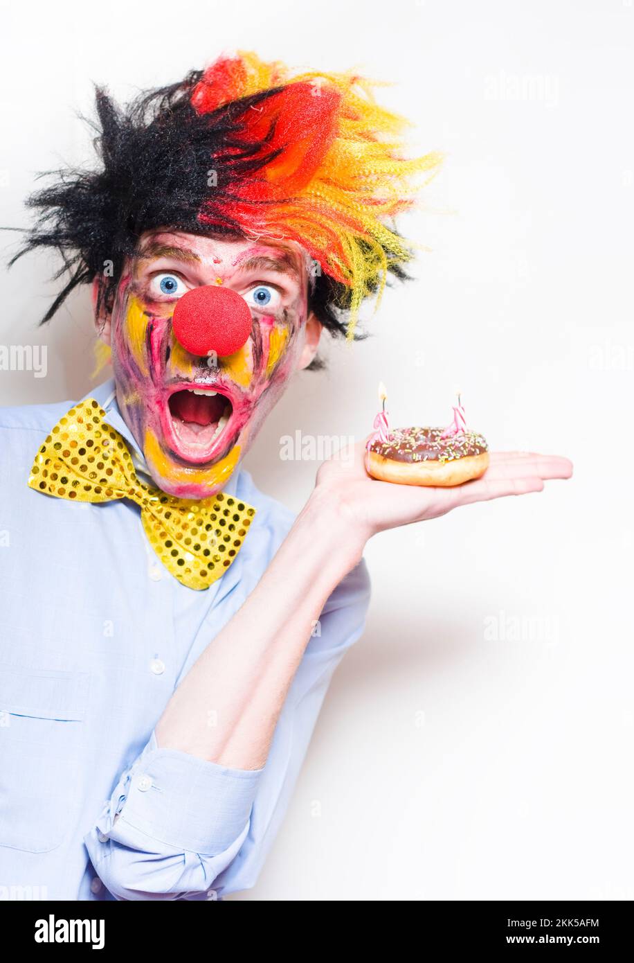 Shocked happy birthday clown holding hi-res stock photography and ...